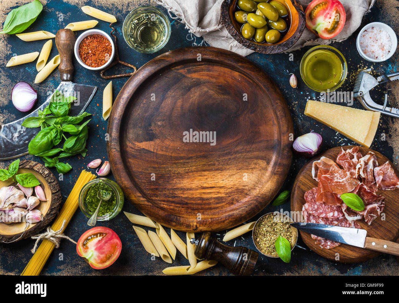 Italian food cooking ingredients on dark plywood background, copy space ...