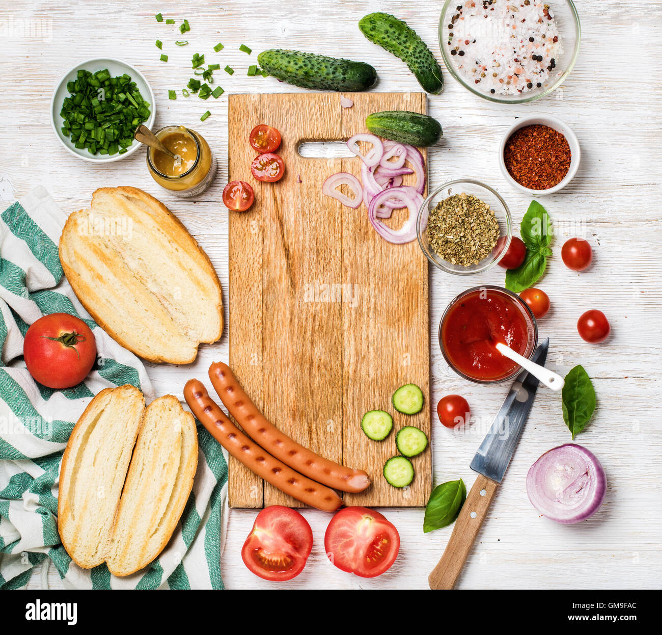 Ingredients for making hot-dogs over white painted wooden background ...