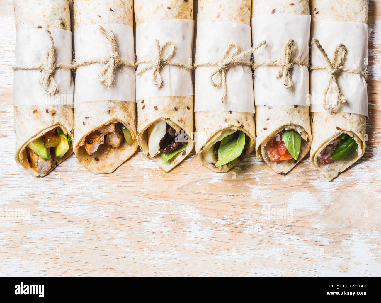 Tortilla wraps with various fillings on shabby white wooden board Stock ...