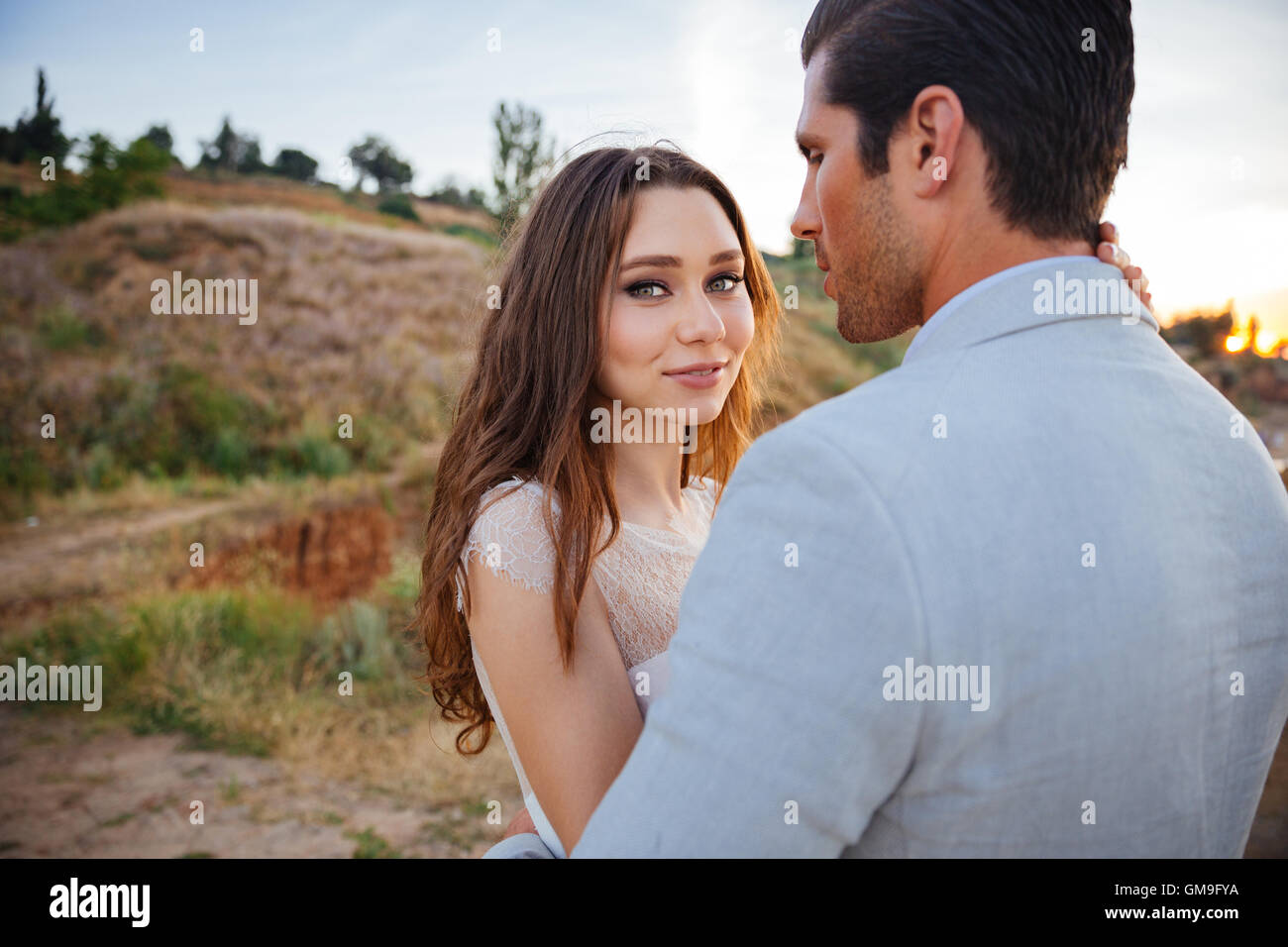 Romantic married beautiful couple kissing and hugging on the beach at ...