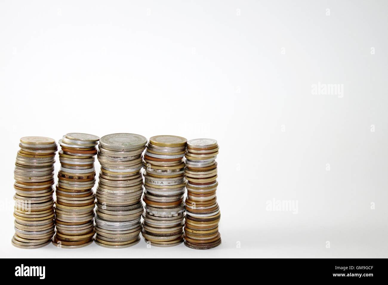 Five piles of coins Stock Photo - Alamy