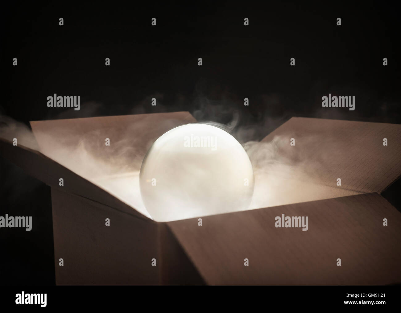 Crystal ball in cardboard box Stock Photo - Alamy