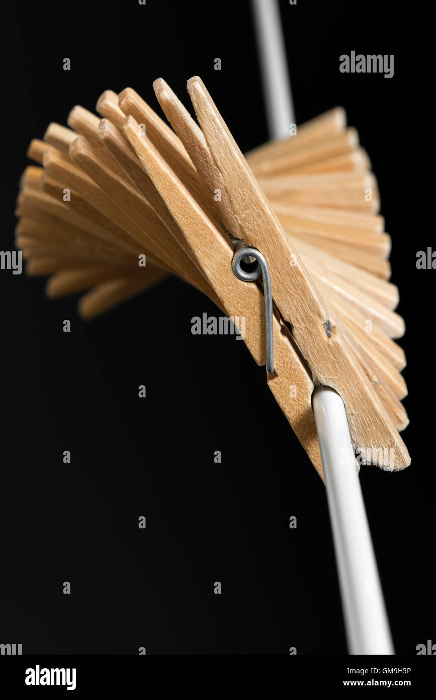 Wooden clothespins in fan shape to a white thread Stock Photo - Alamy