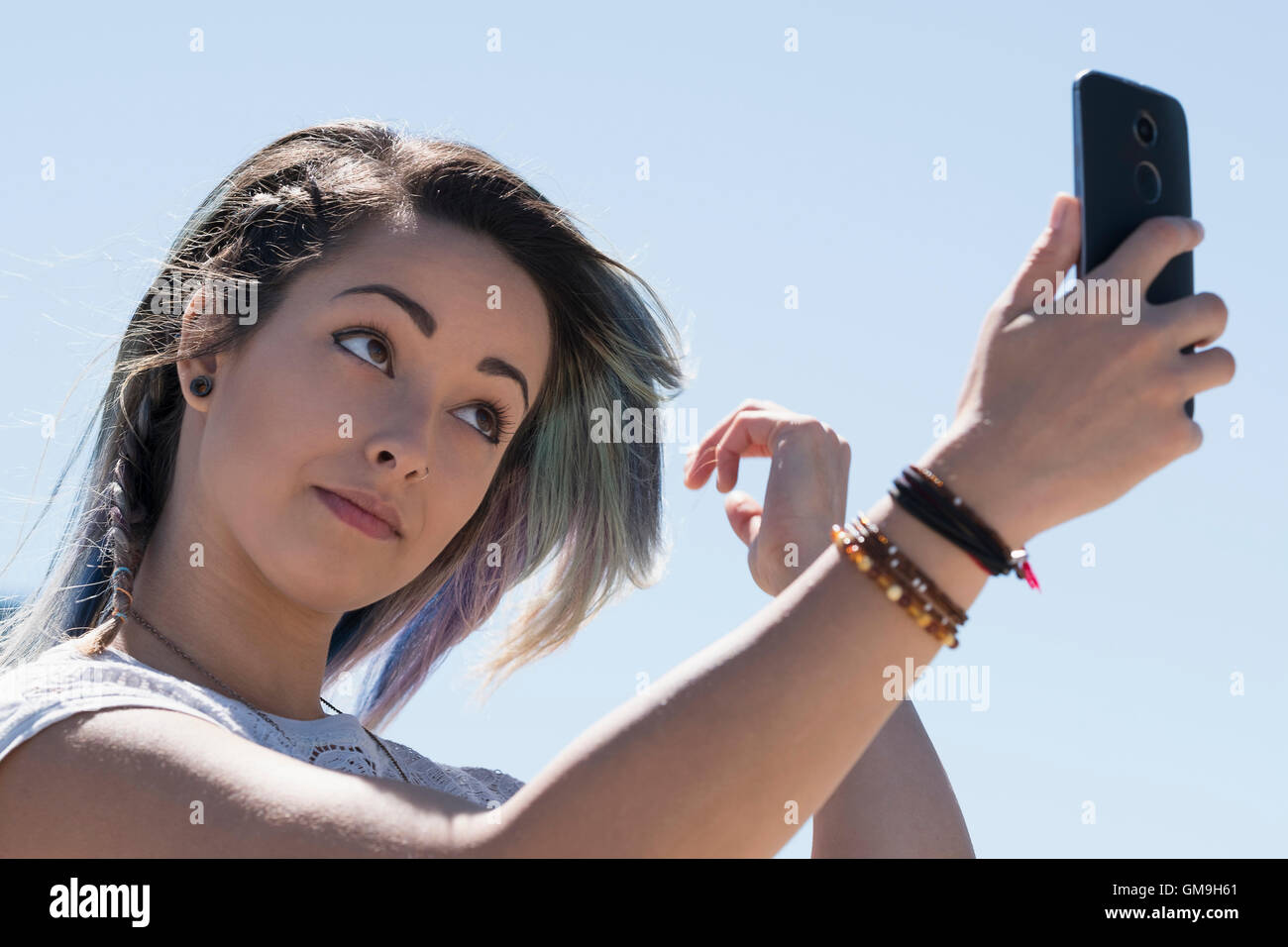 Young woman holding mobile phone Stock Photo - Alamy