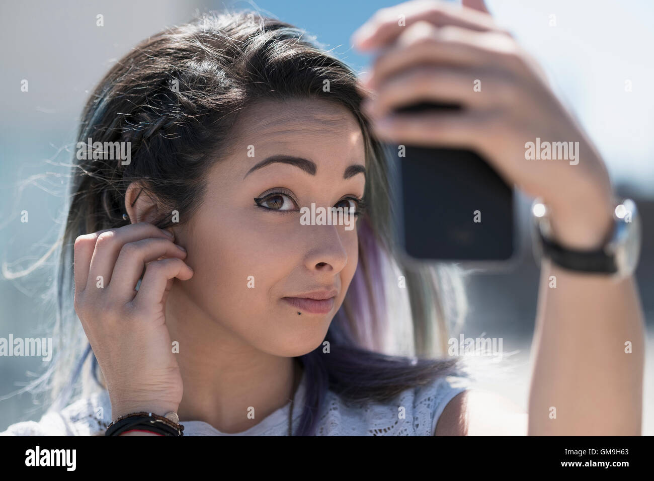 Young woman holding mobile phone Stock Photo - Alamy