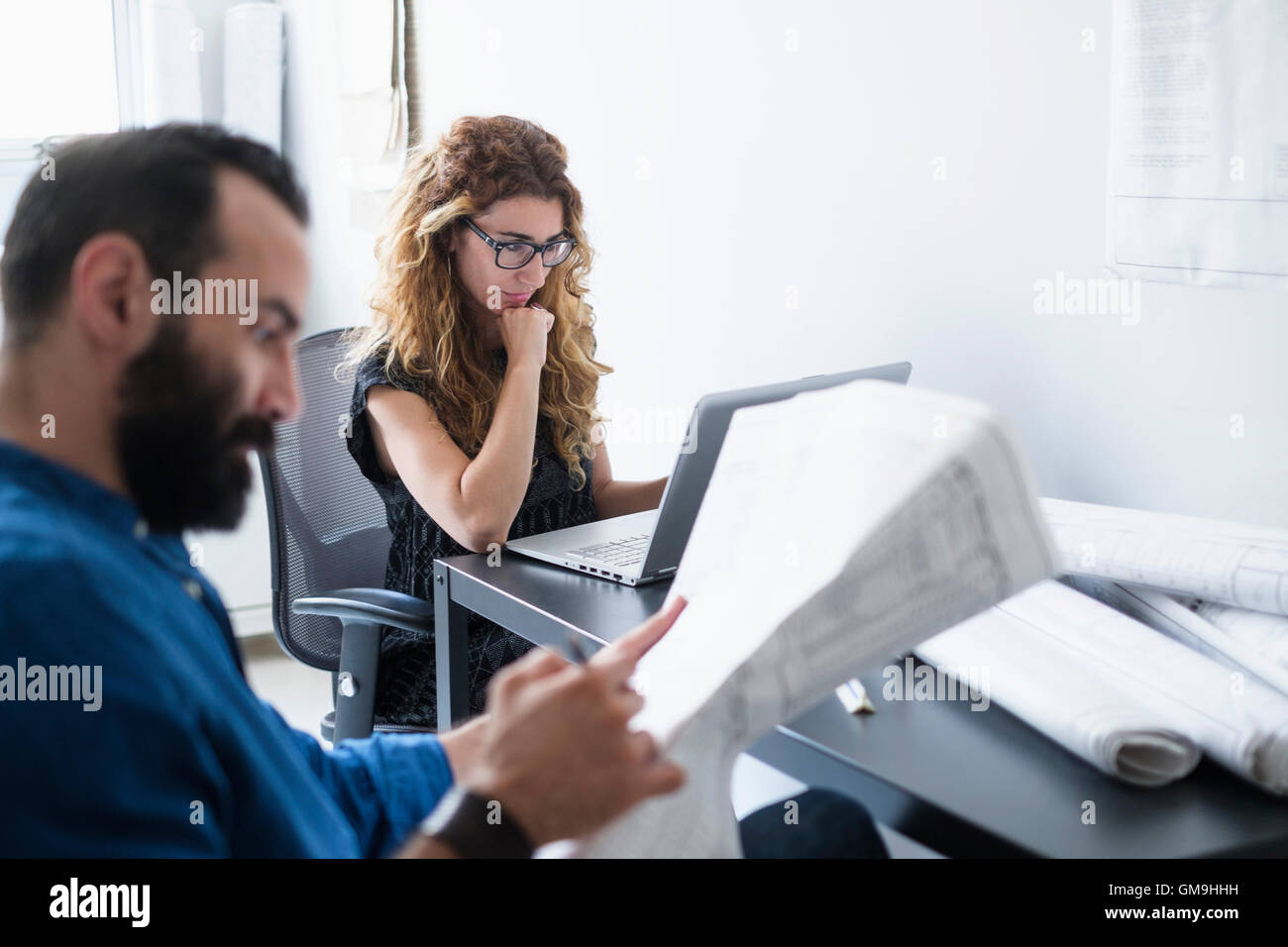 Man and woman working together in office Stock Photo - Alamy