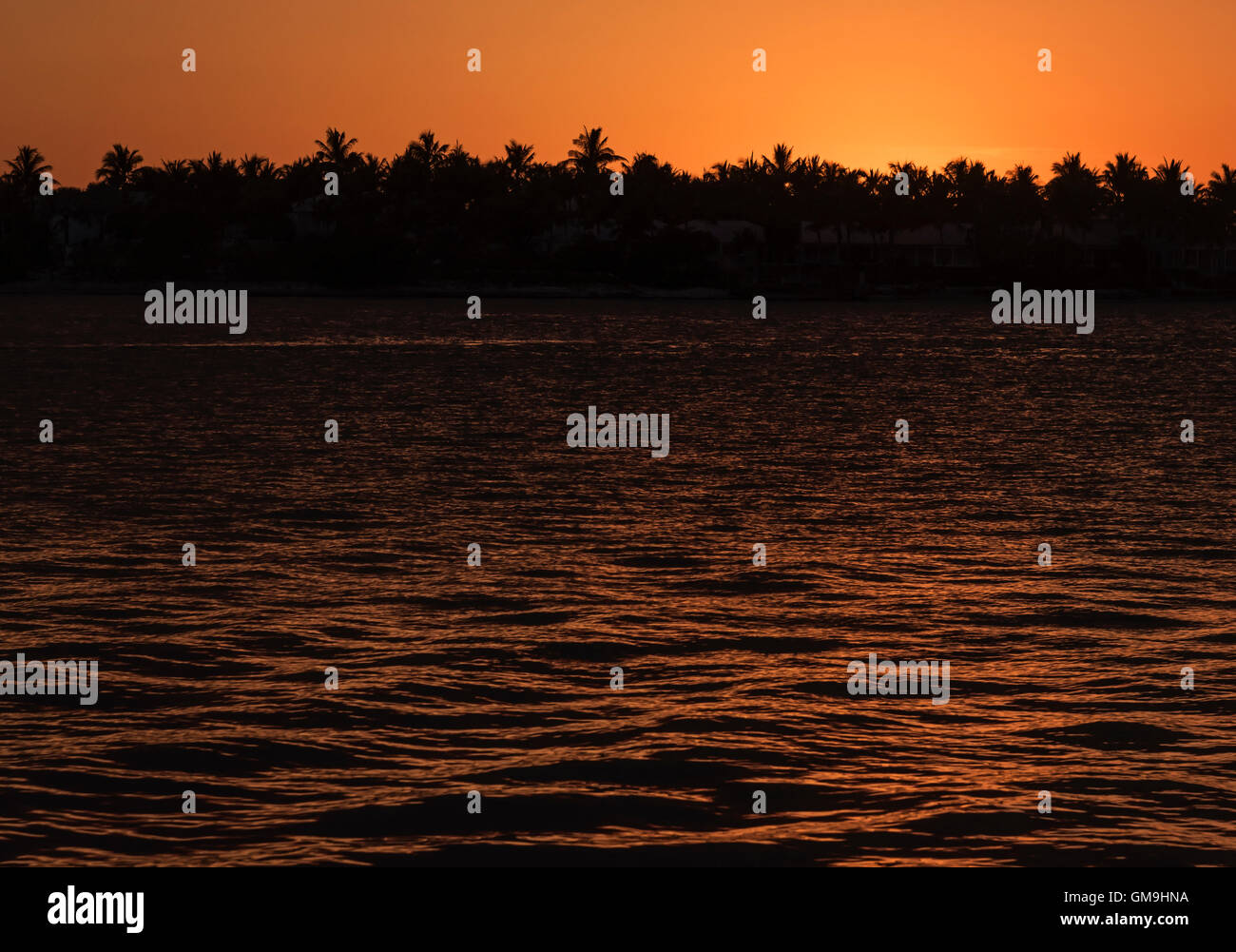 Sunset over island Stock Photo - Alamy