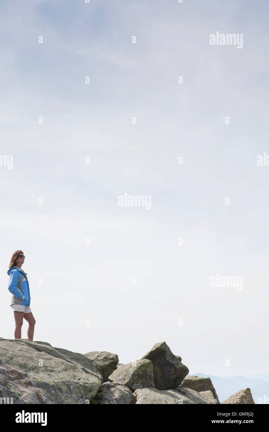 Woman standing at rocks hi-res stock photography and images - Alamy