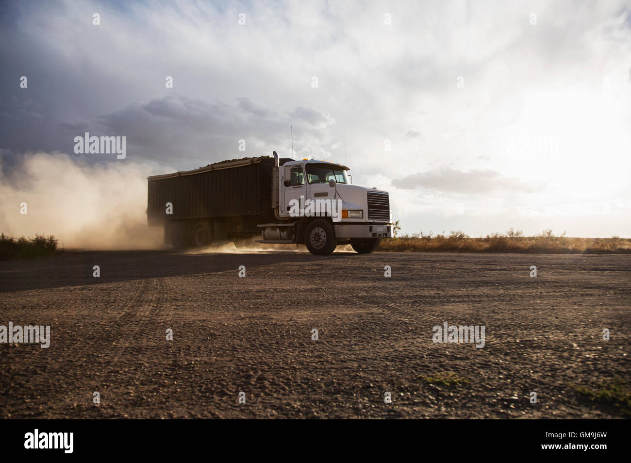 Truck driving in field Stock Photo - Alamy