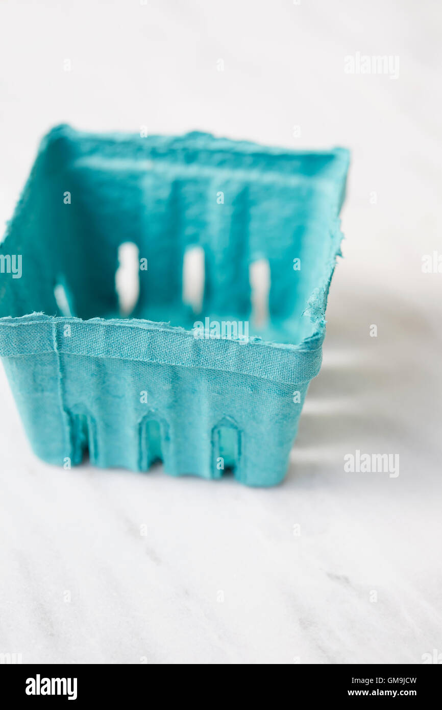 Empty blue fruit carton on marble table Stock Photo - Alamy
