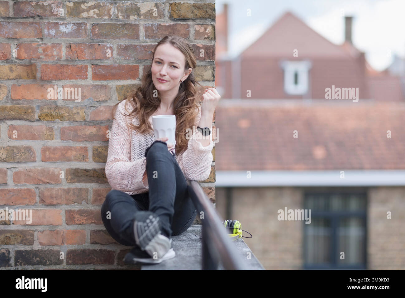 Woman leaning on balcony hi-res stock photography and images - Alamy