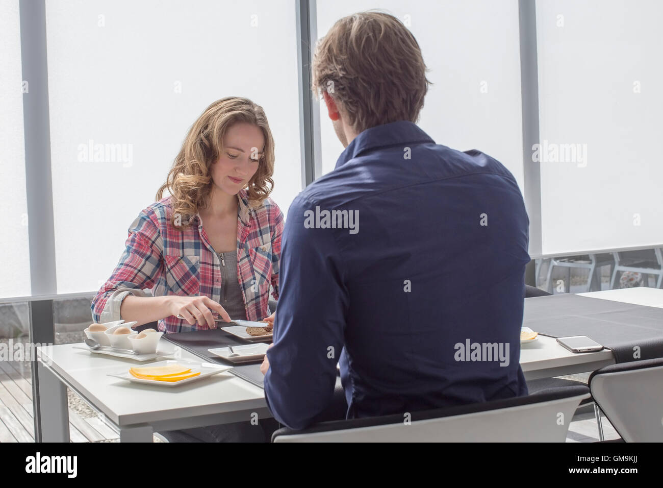 Mid-adult couple eating breakfast Stock Photo - Alamy
