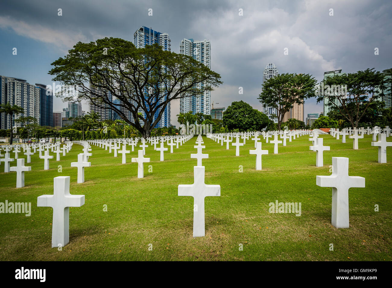 Graves and modern buildings in the distance at the Manila American ...