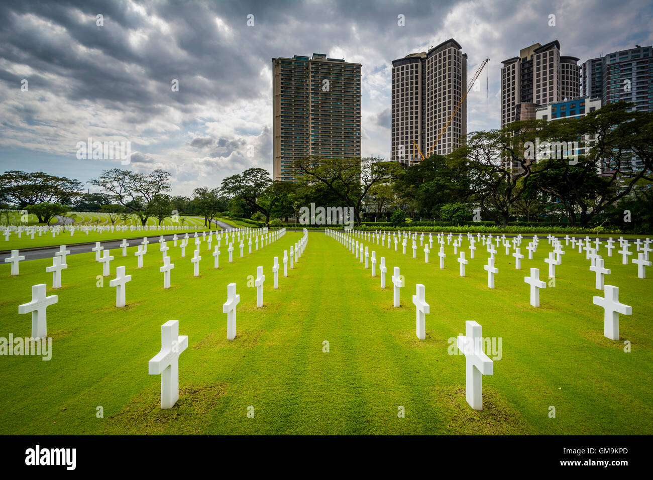 Graves and modern buildings in the distance at the Manila American ...