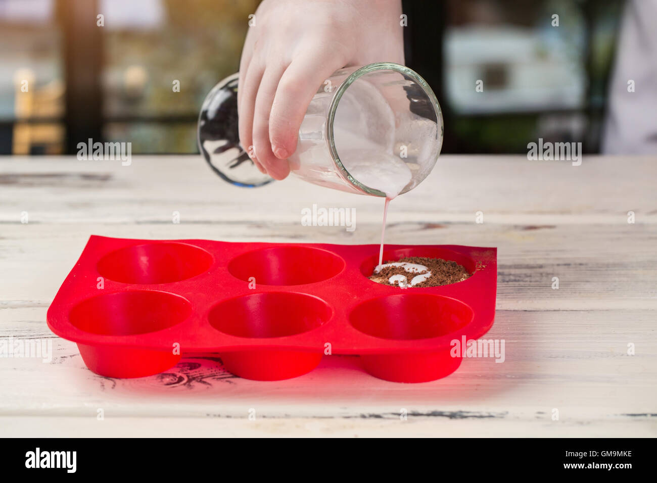 White liquid pours into mold Stock Photo - Alamy