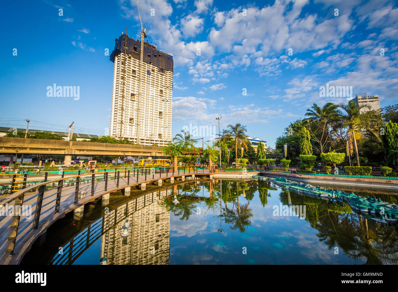 Pond at Rizal Park and highrise under construction, in Ermita, Manila ...