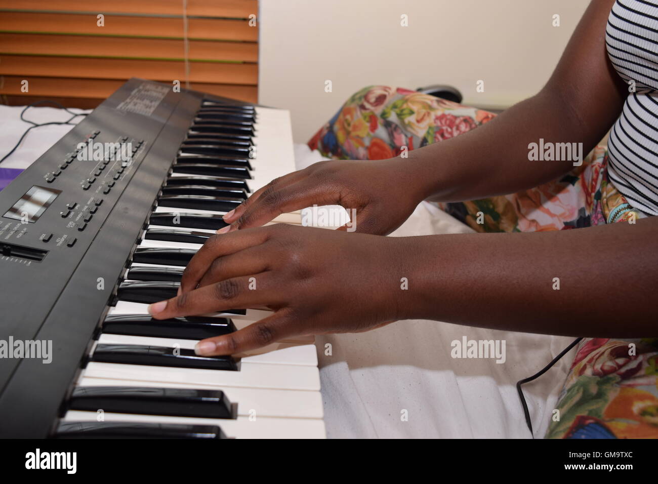 Girl Practicing the Keyboard Stock Photo - Alamy