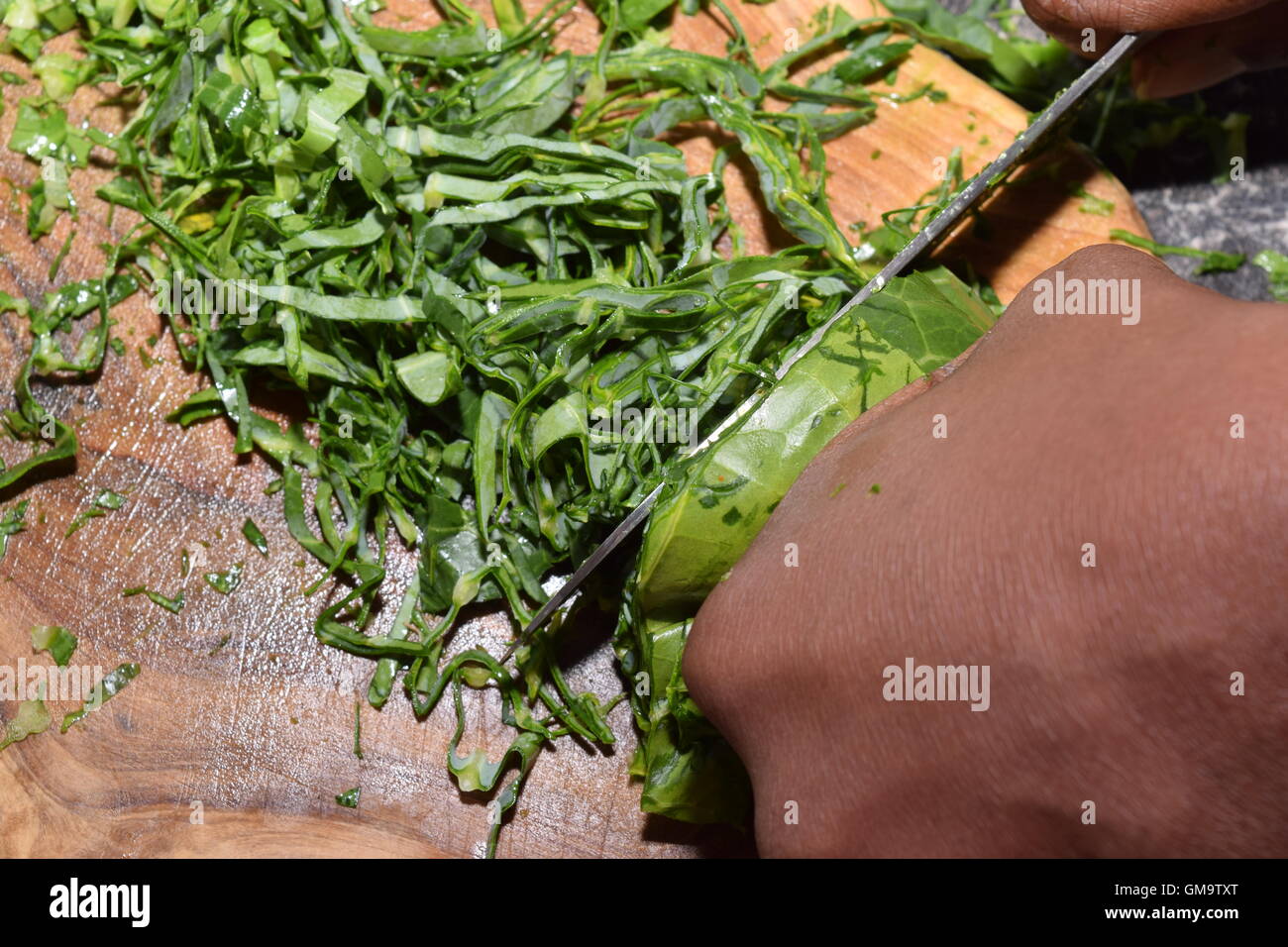 African Hand Chopping Fresh Greens Stock Photo - Alamy