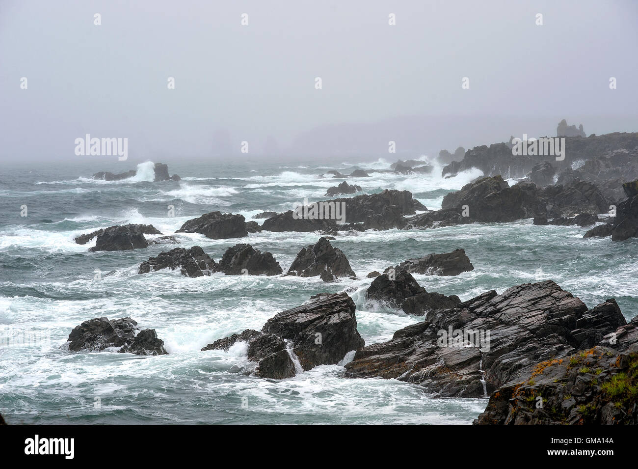 Waves splashing against rocky shoreline Stock Photo - Alamy