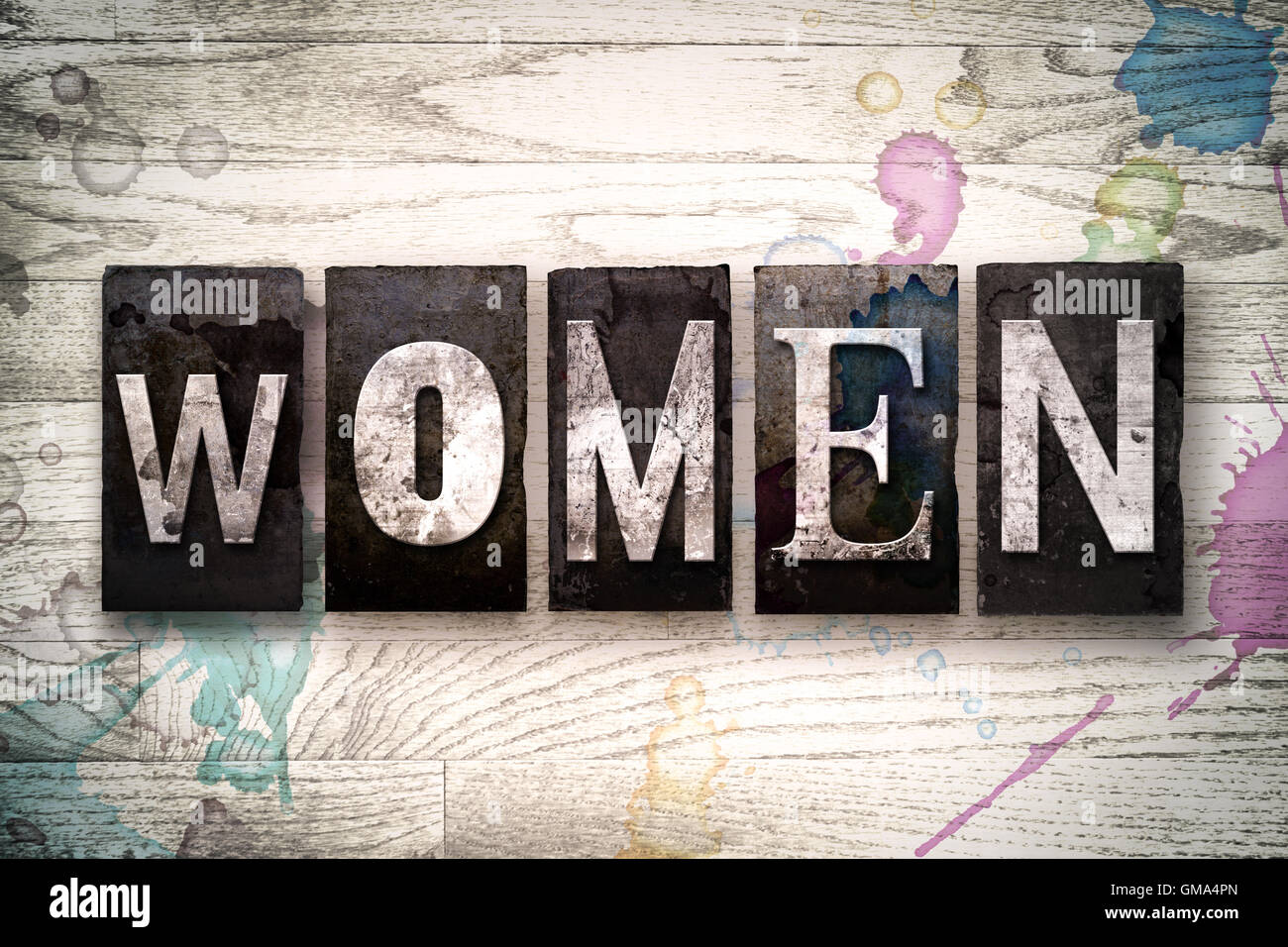 The word "WOMEN" written in vintage dirty metal letterpress type on a ...