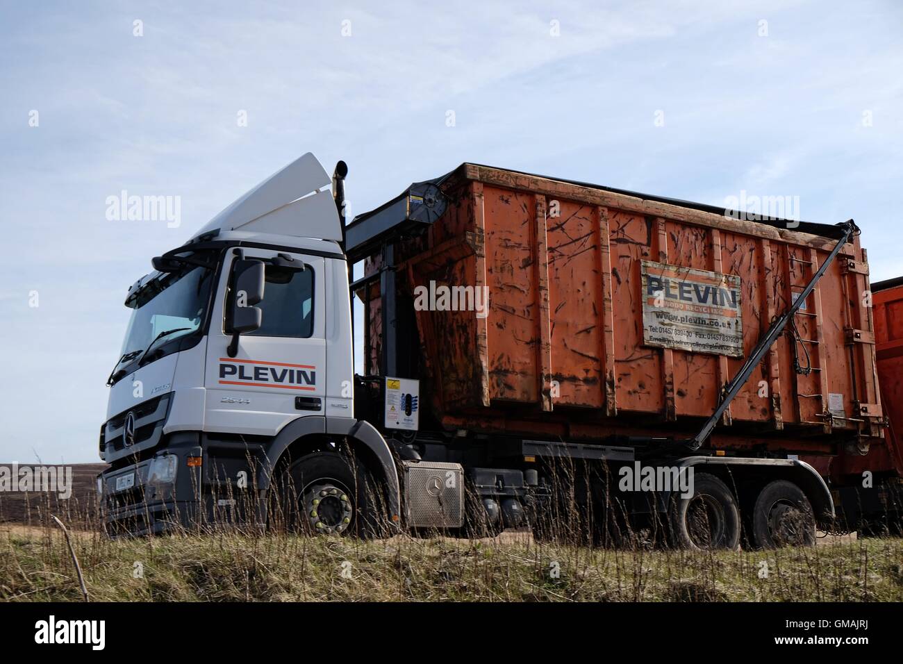 A Mercedes Actros three-axle, wood recycling tipper truck pulling a ...