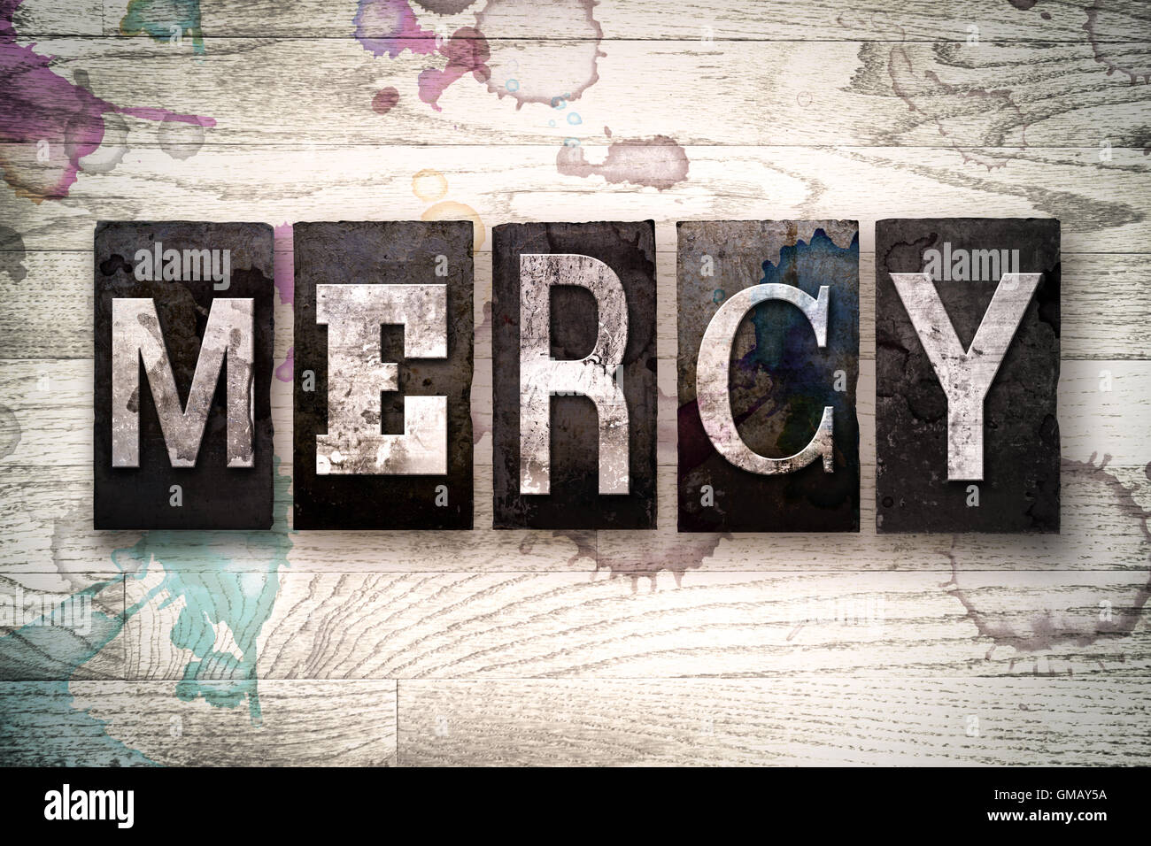 The word "MERCY" written in vintage dirty metal letterpress type on a ...