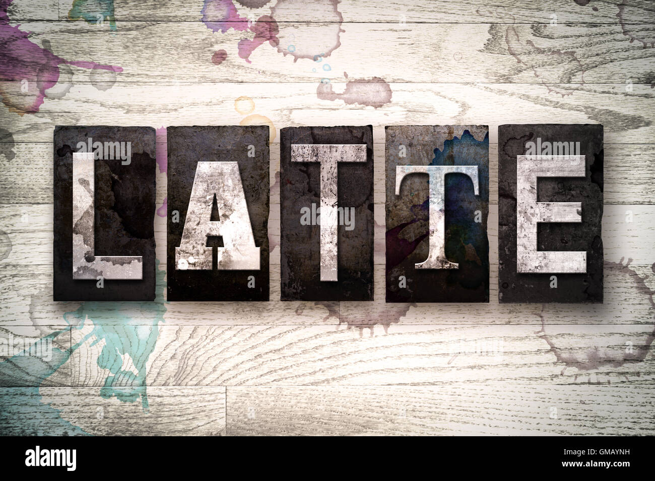 The word "LATTE" written in vintage dirty metal letterpress type on a ...