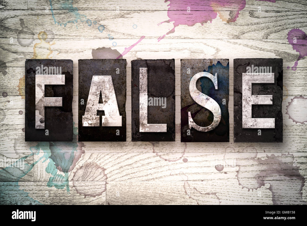 The word "FALSE" written in vintage dirty metal letterpress type on a ...