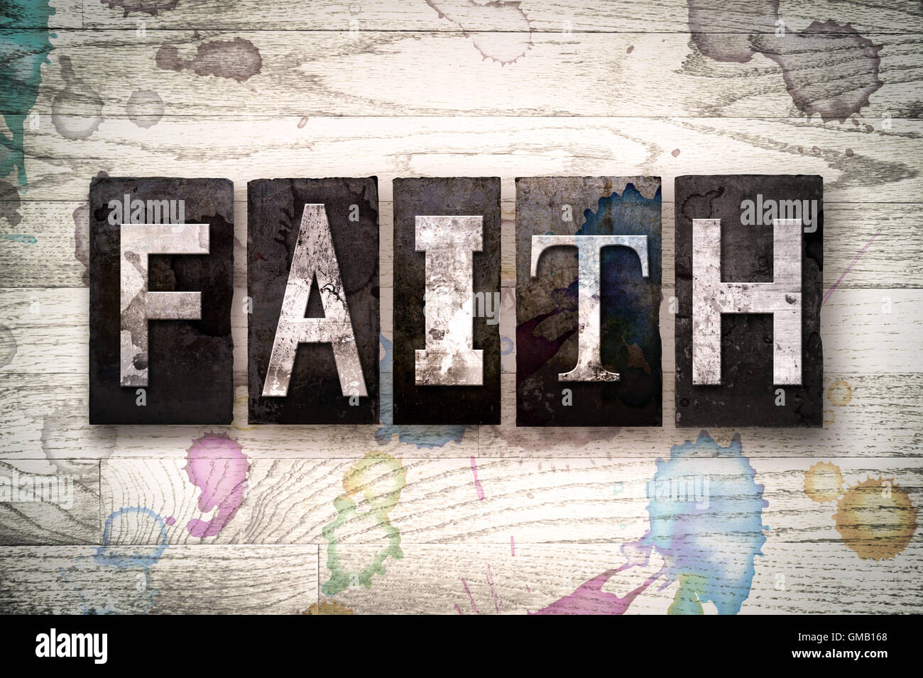 The word "FAITH" written in vintage dirty metal letterpress type on a ...