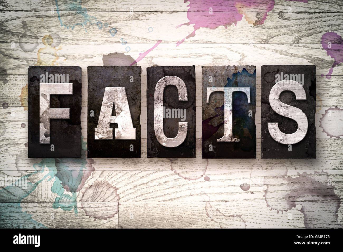 The word "FACTS" written in vintage dirty metal letterpress type on a ...