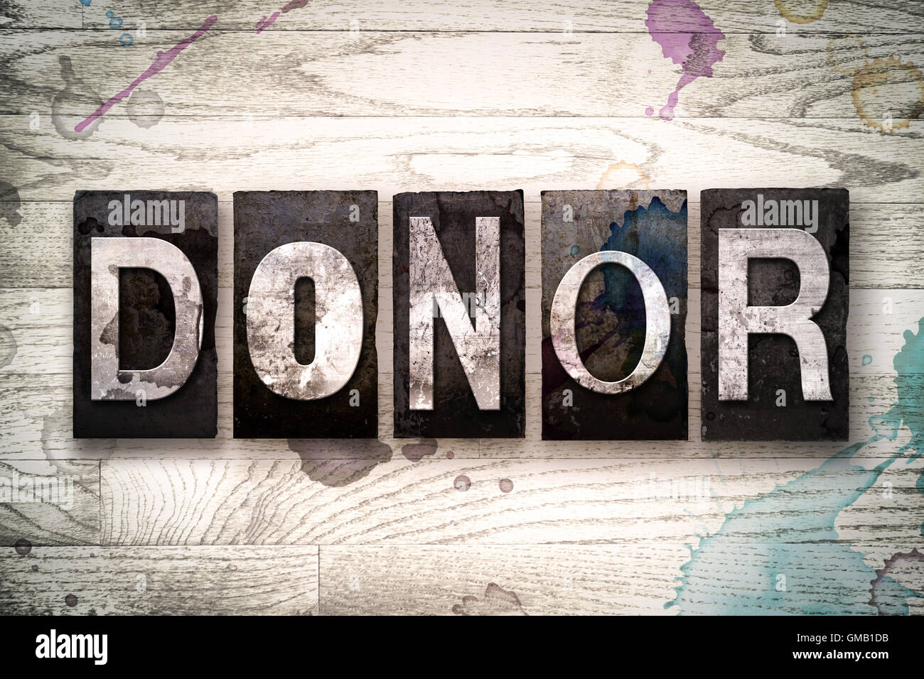 The word "DONOR" written in vintage dirty metal letterpress type on a ...