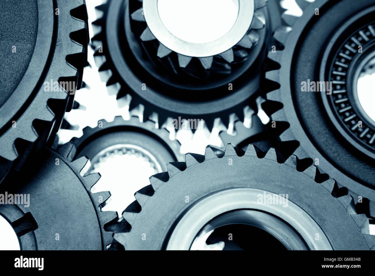 Metal cog wheels bonding together Stock Photo - Alamy