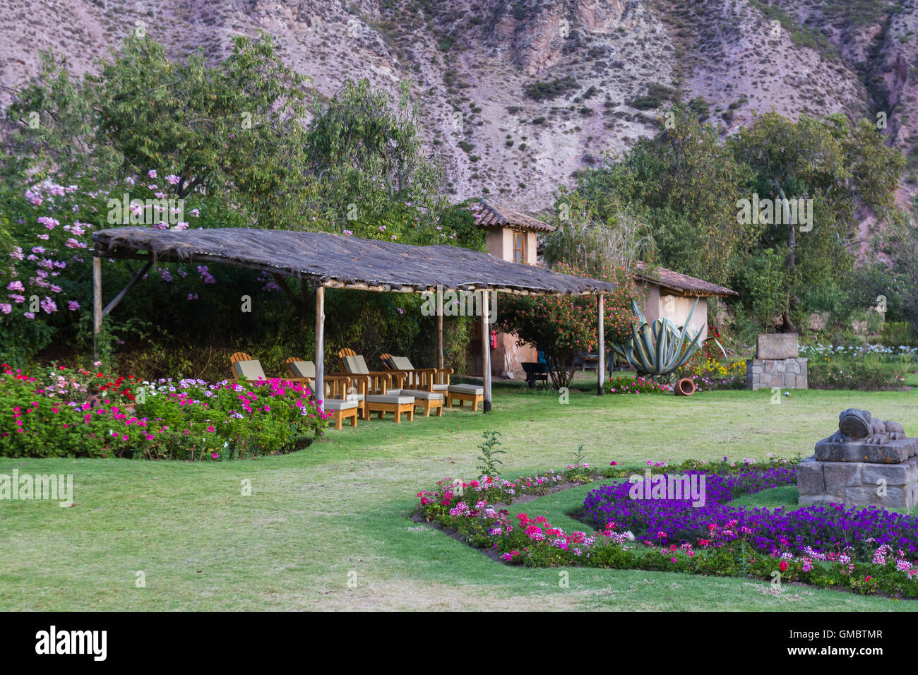 beautiful hotel back yard with flowers and comfortable chairs for ...