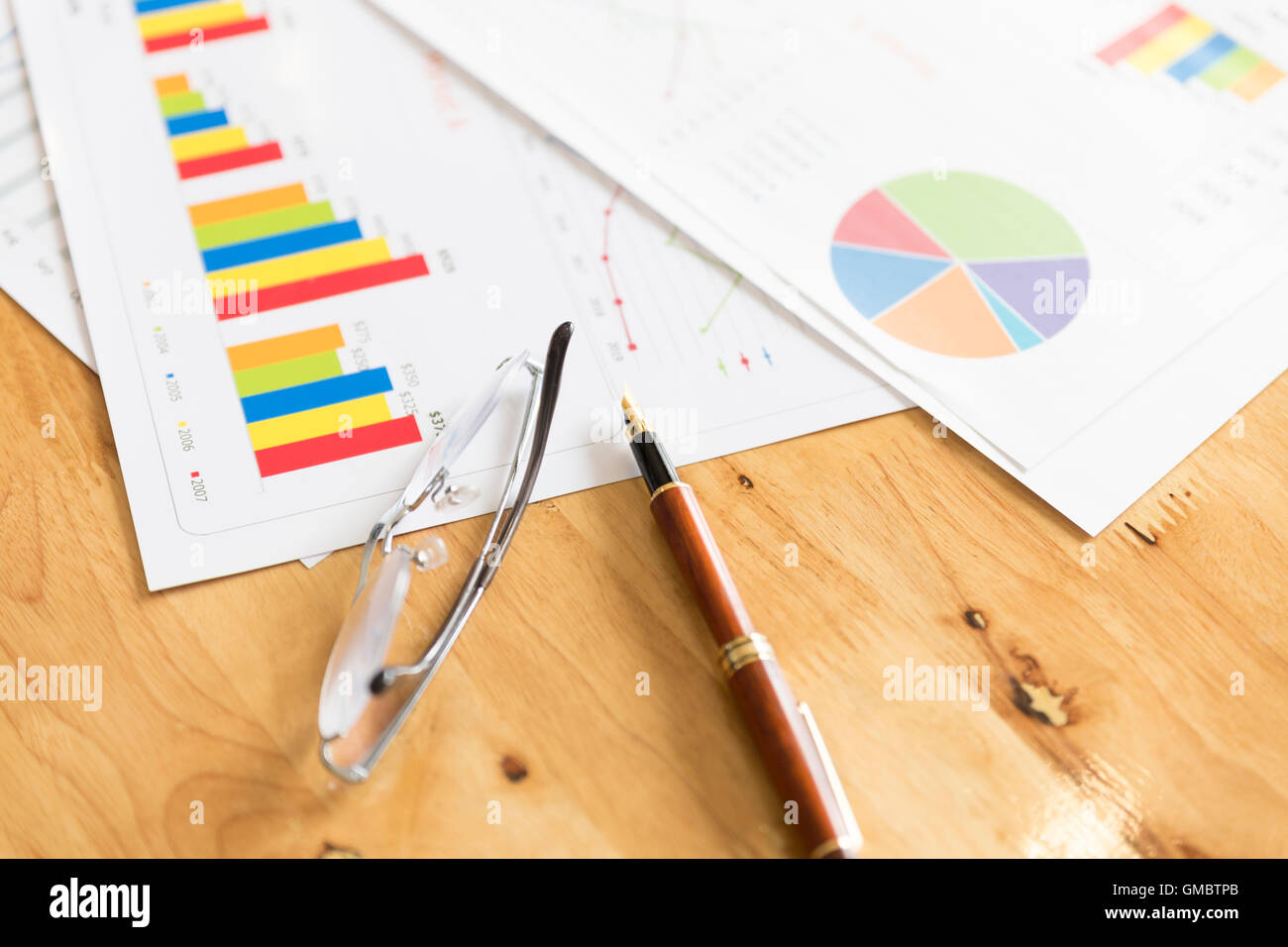 graph and chart analysis paperwork document with eyeglasses and pen on ...