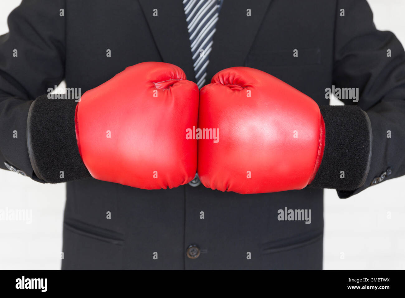 businessman in necktie and suit with red boxing gloves - business ...