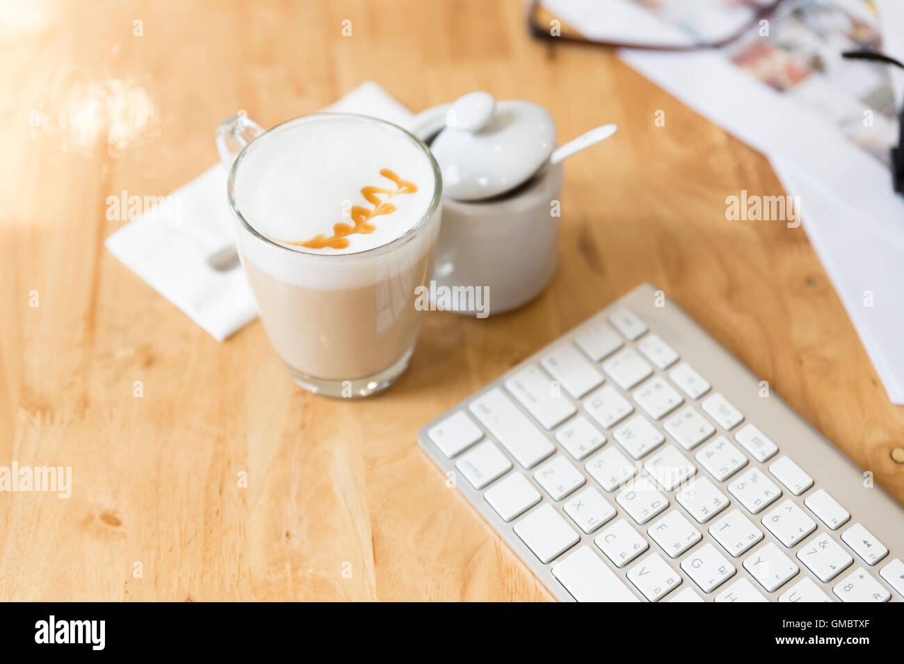 computer keyboard with hot cappuccino coffee drink cup with sugar mug ...