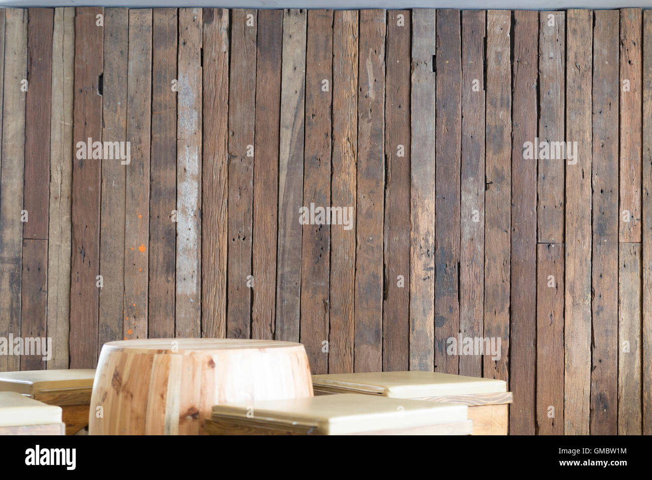 table and stool beside wooden board wall Stock Photo - Alamy