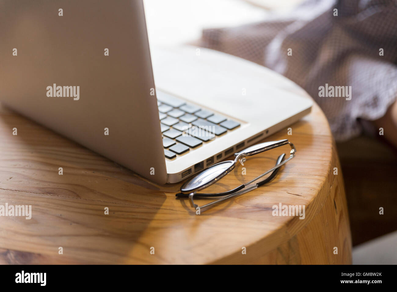 eyeglasses with laptop computer notebook on wooden desk with background ...