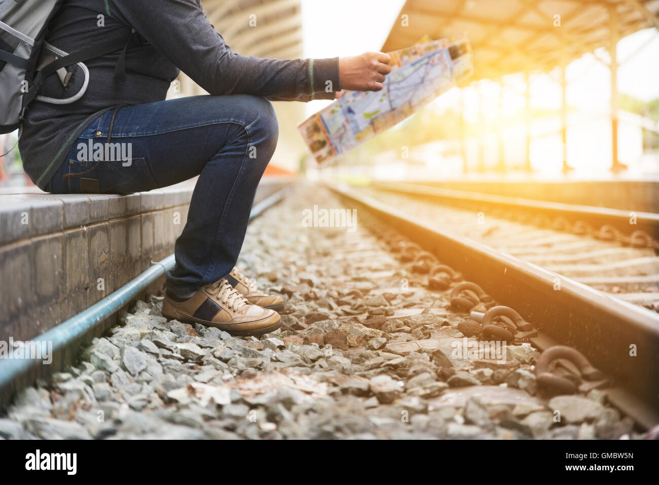 Man sitting on railway platform hi-res stock photography and images - Alamy