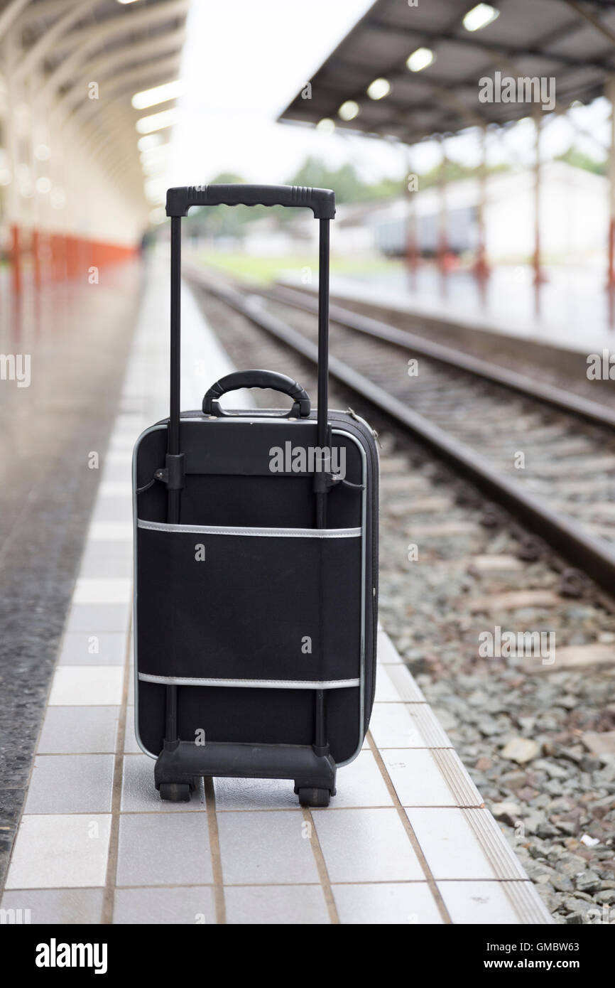 black baggage bag on platform at train station - travel concept Stock ...