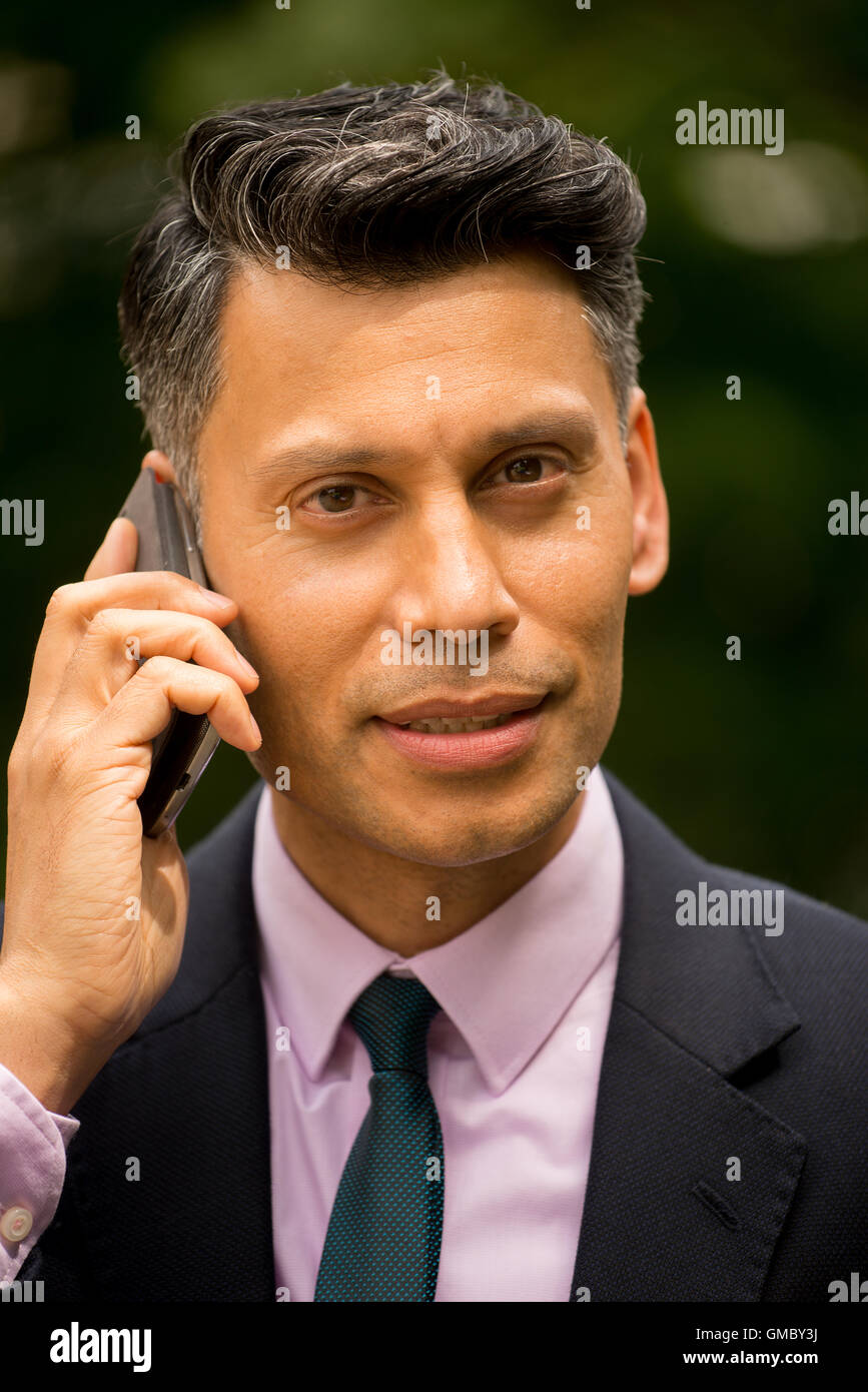 Smartly dressed businessman talking on his mobile phone Stock Photo - Alamy
