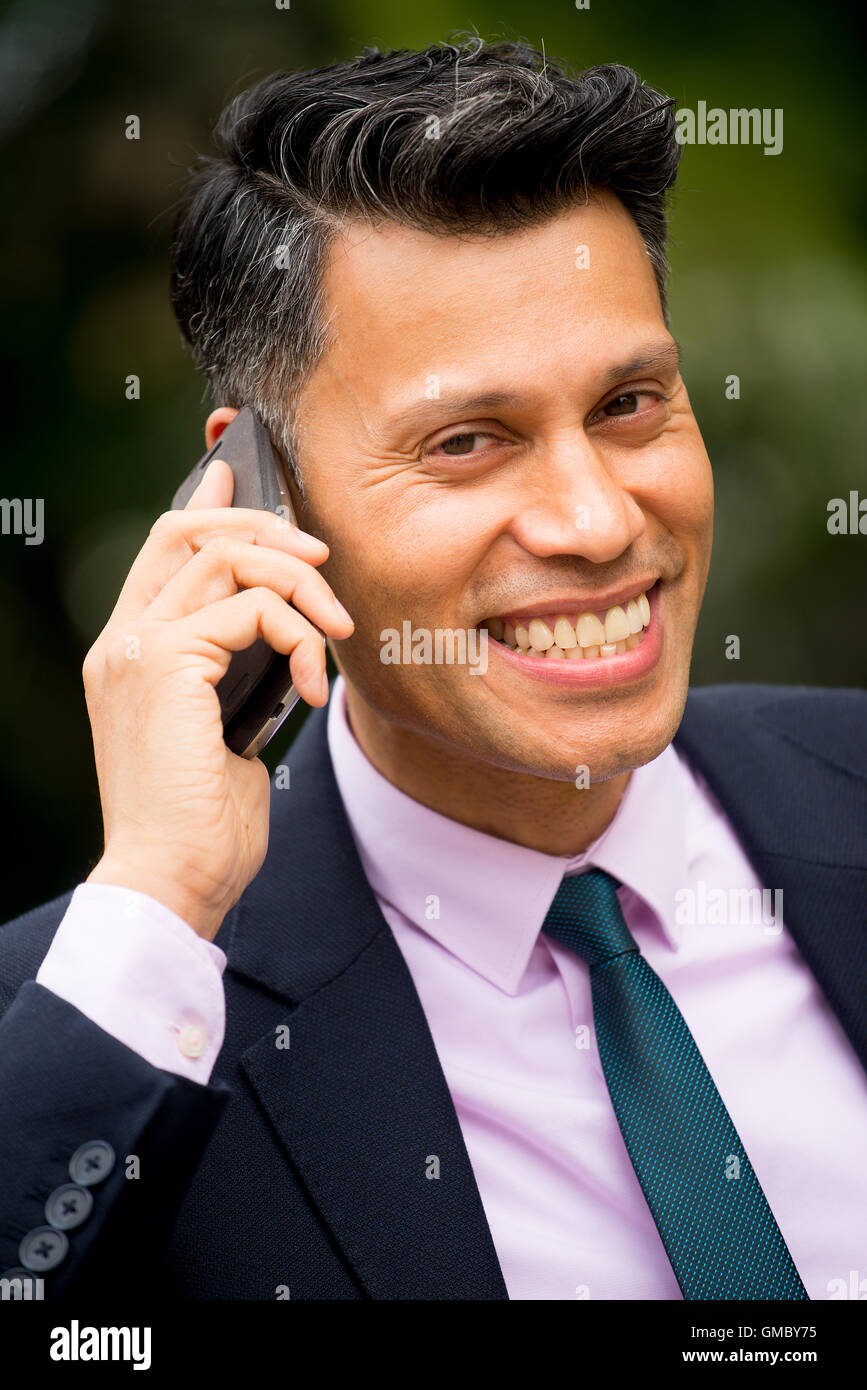 Smartly dressed businessman talking on his mobile phone Stock Photo - Alamy