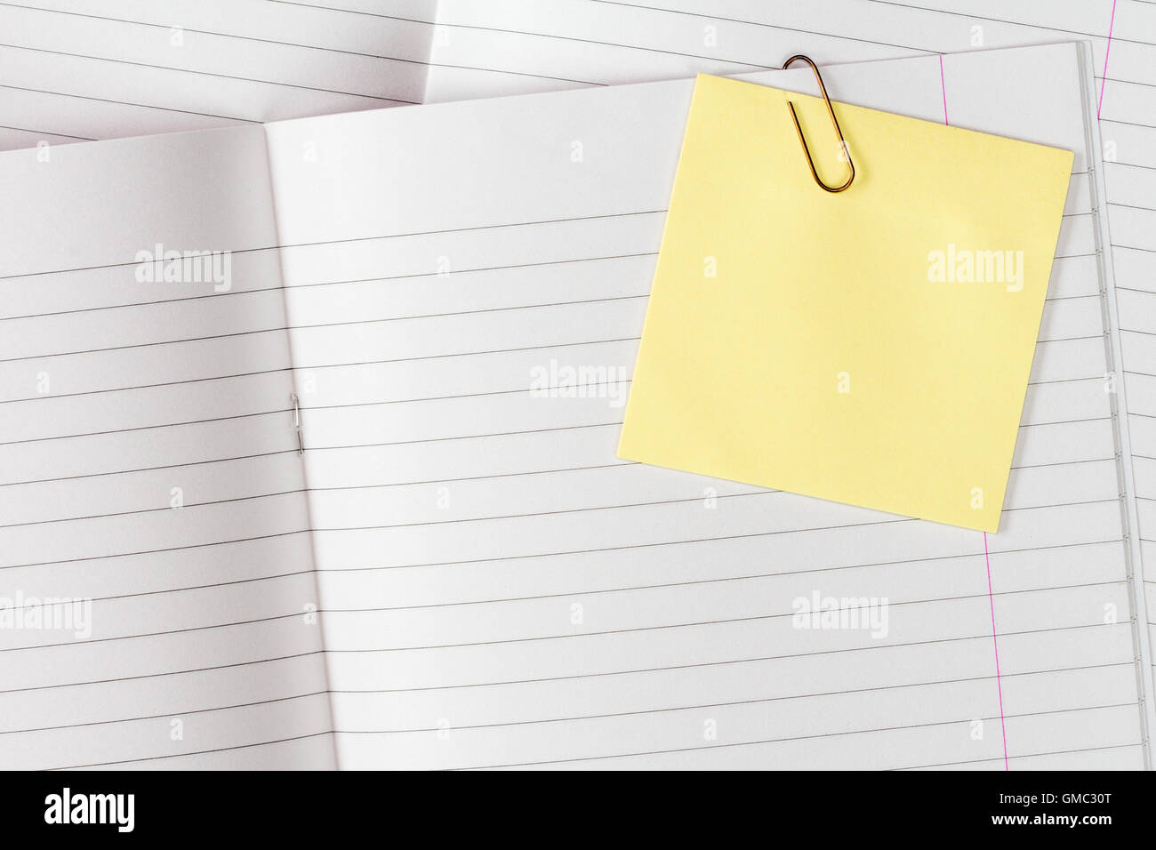 Lined exercise books with blank yellow sticky note Stock Photo - Alamy