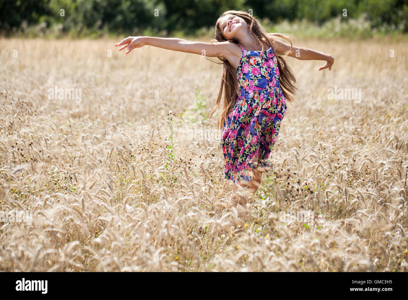 Happy little girl running in summer field Stock Photo - Alamy