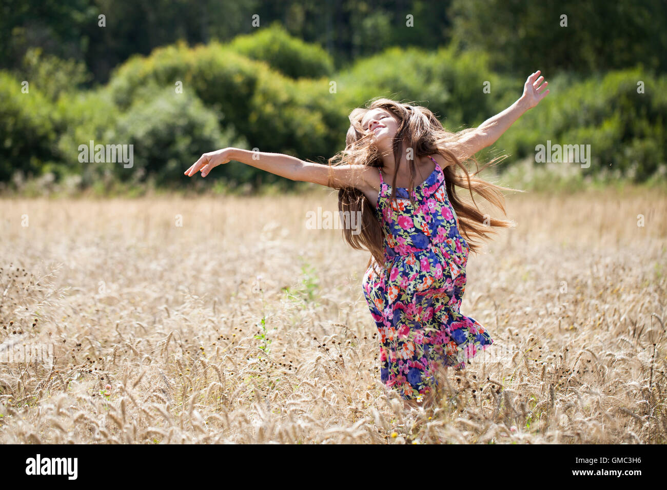 Happy little girl running in summer field Stock Photo - Alamy