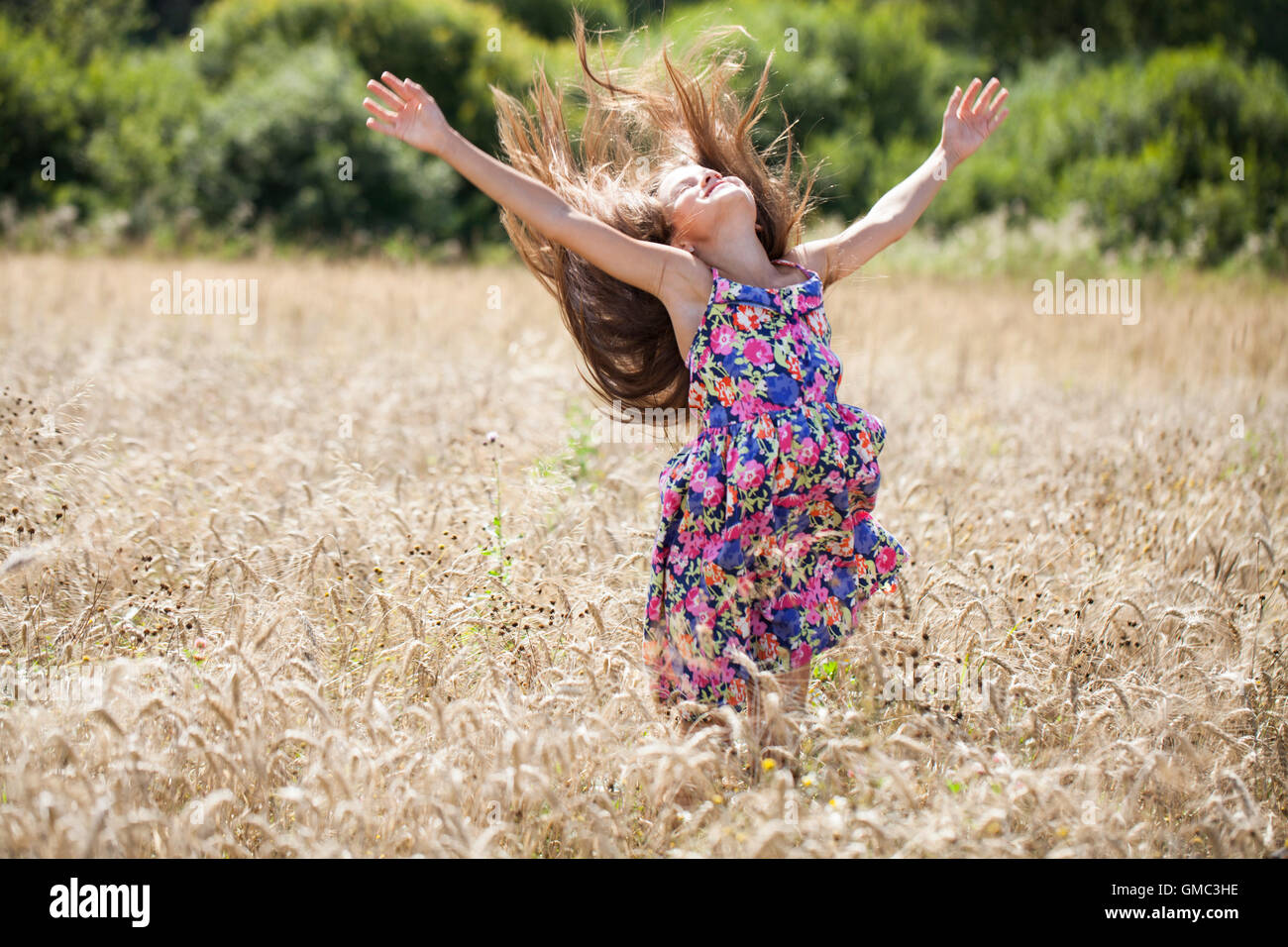 Happy little girl running in summer field Stock Photo - Alamy
