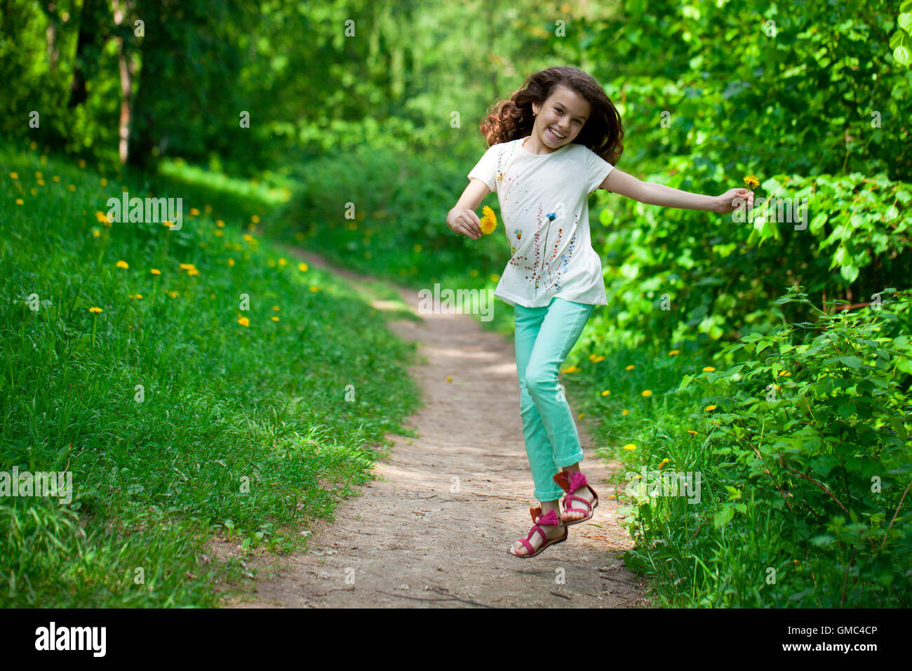 Happy little girl running in summer park Stock Photo - Alamy