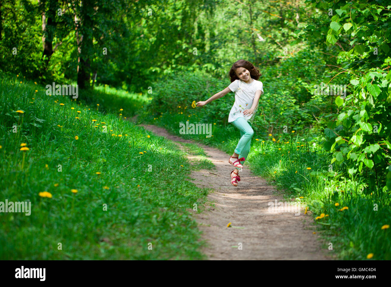 Happy little girl running in summer park Stock Photo - Alamy