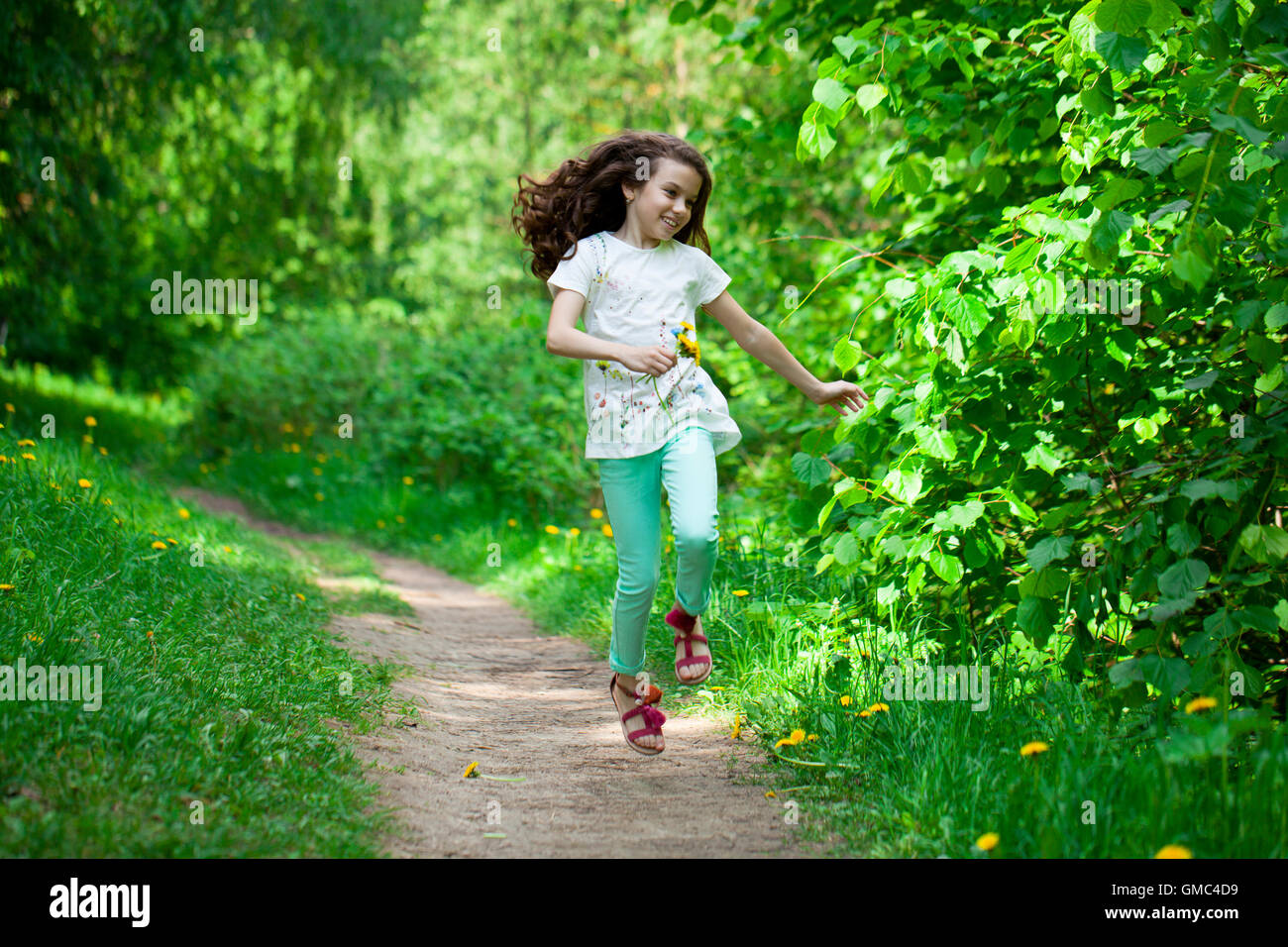 Happy little girl running in summer park Stock Photo - Alamy