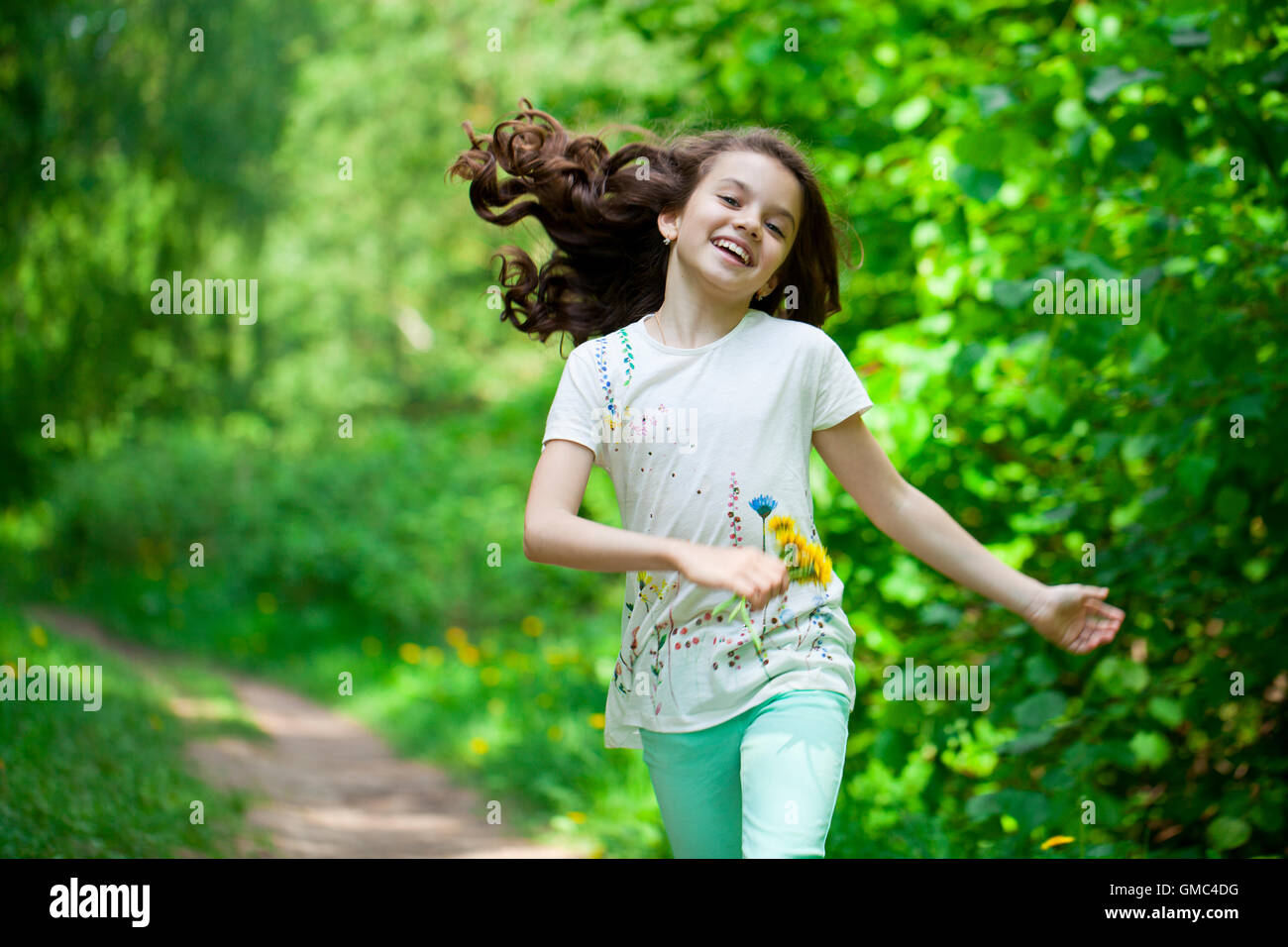 Happy little girl running in summer park Stock Photo - Alamy